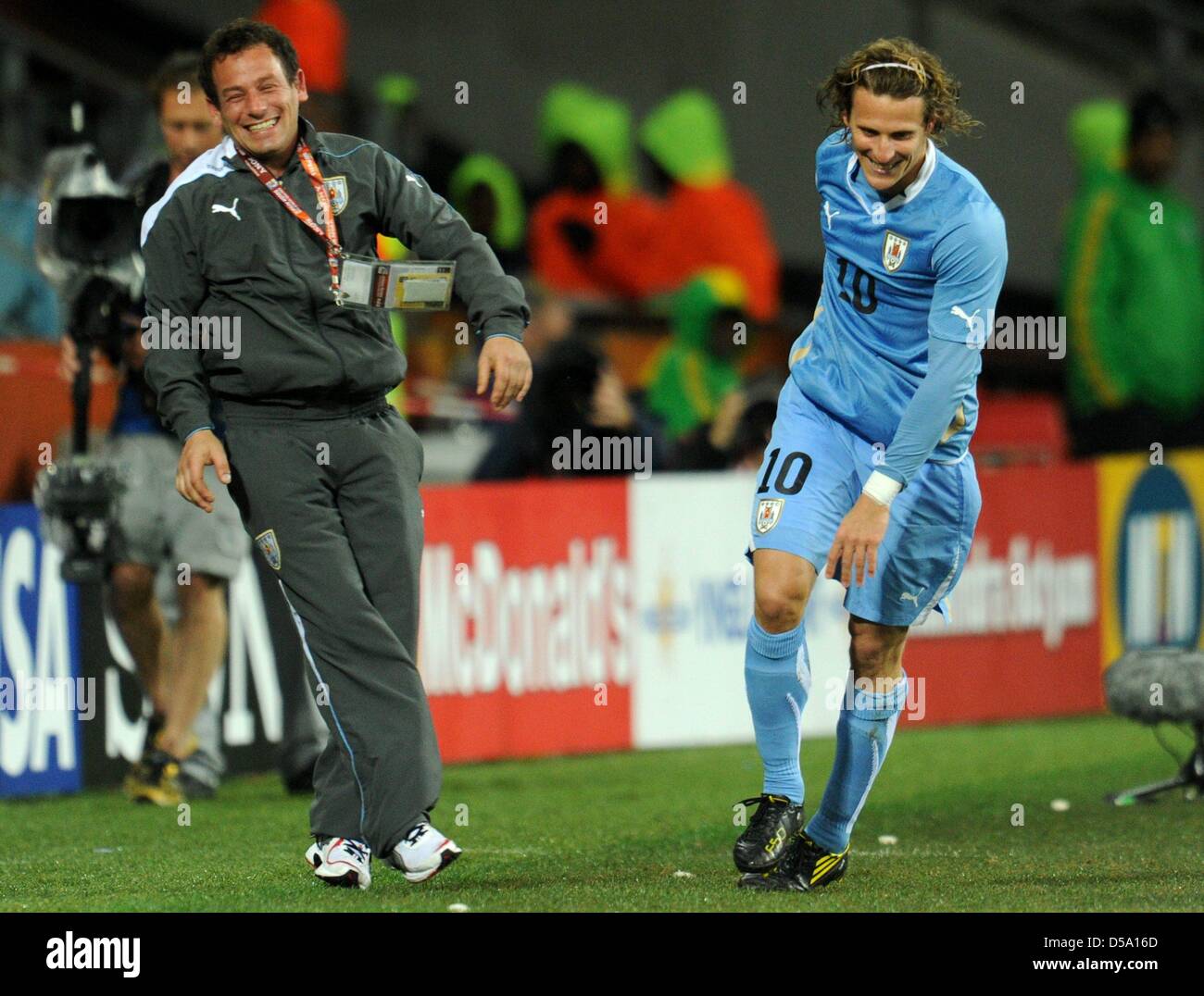 Diego Forlan (R) of Uruguay celebrates after scoring the 2-1 lead for ...