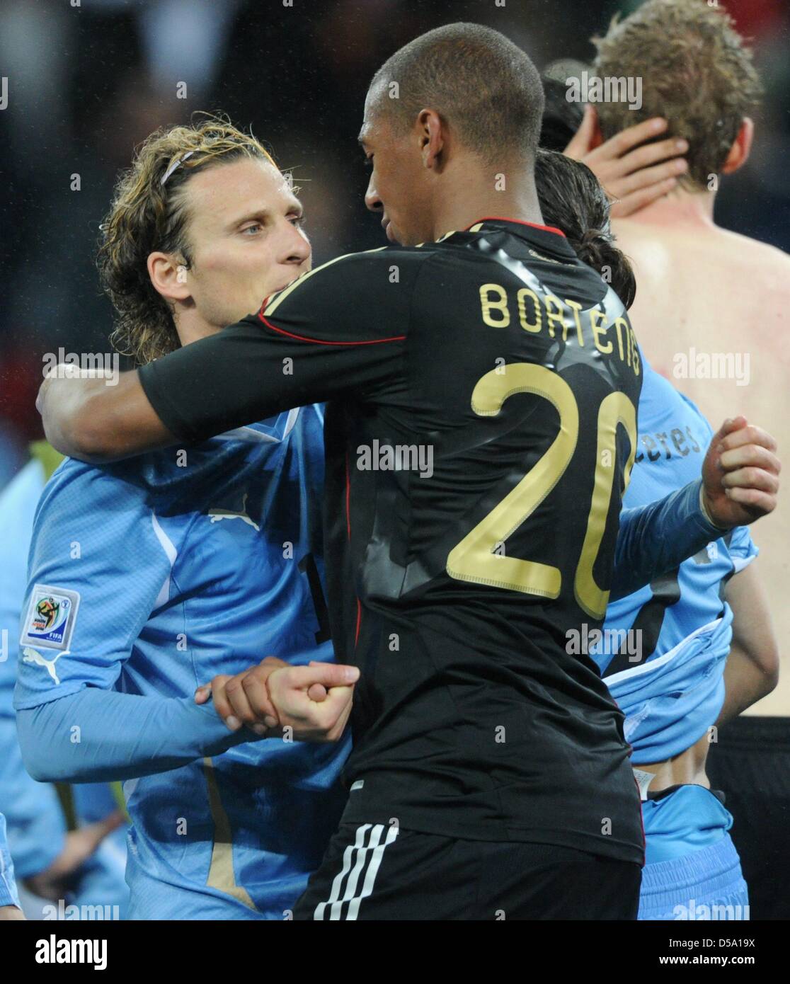Germany's Jerome Boateng (R) embraces Uruguay's Diego Forlan after the ...