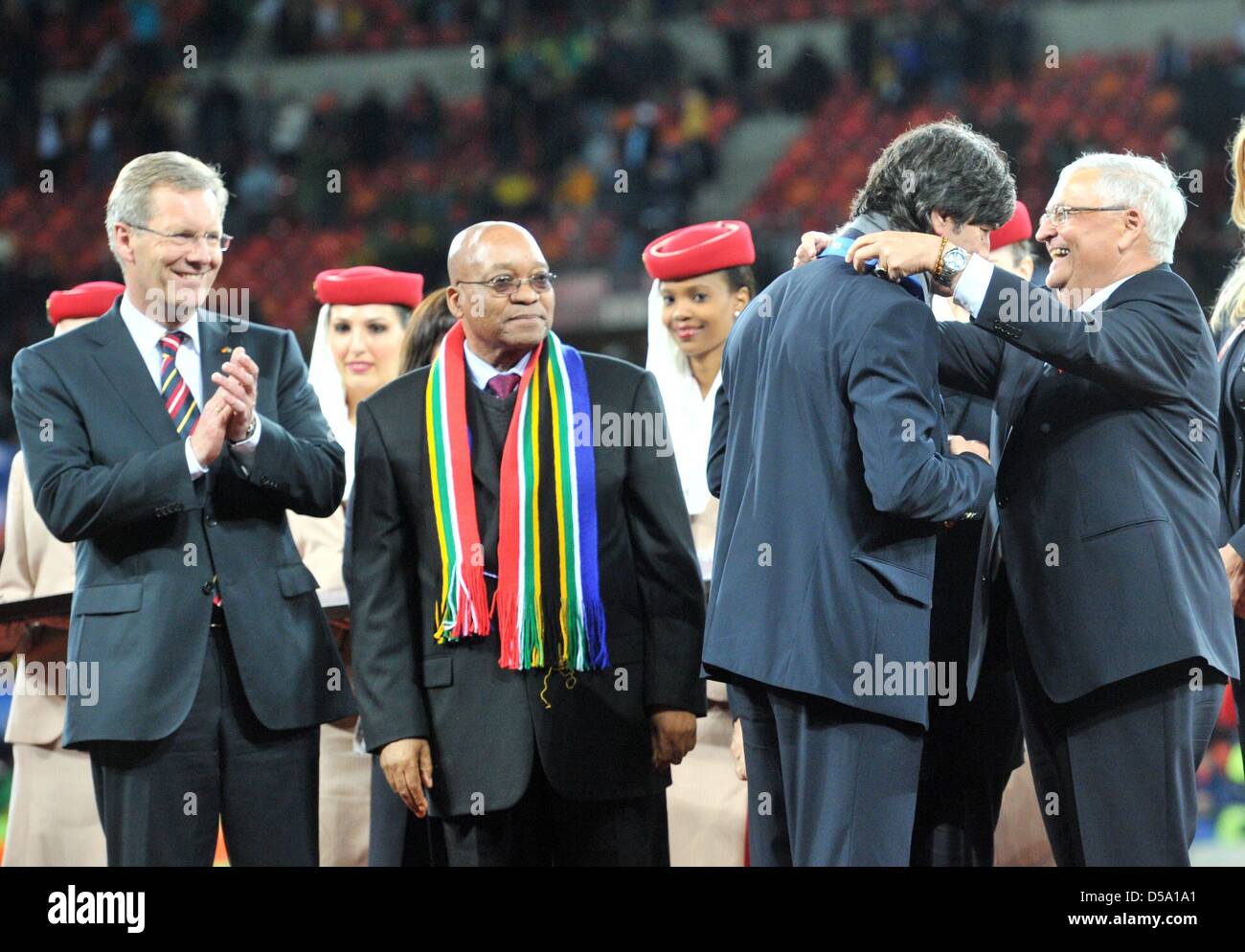 German headcoach Joachim Loew (2-R) receives the bronze medal from Theo ...