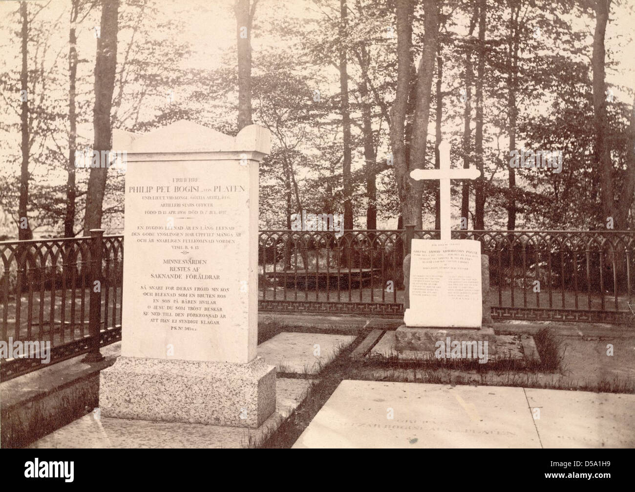 A cemetery in Motala, Sweden, featuring tombstones and wrought iron ...