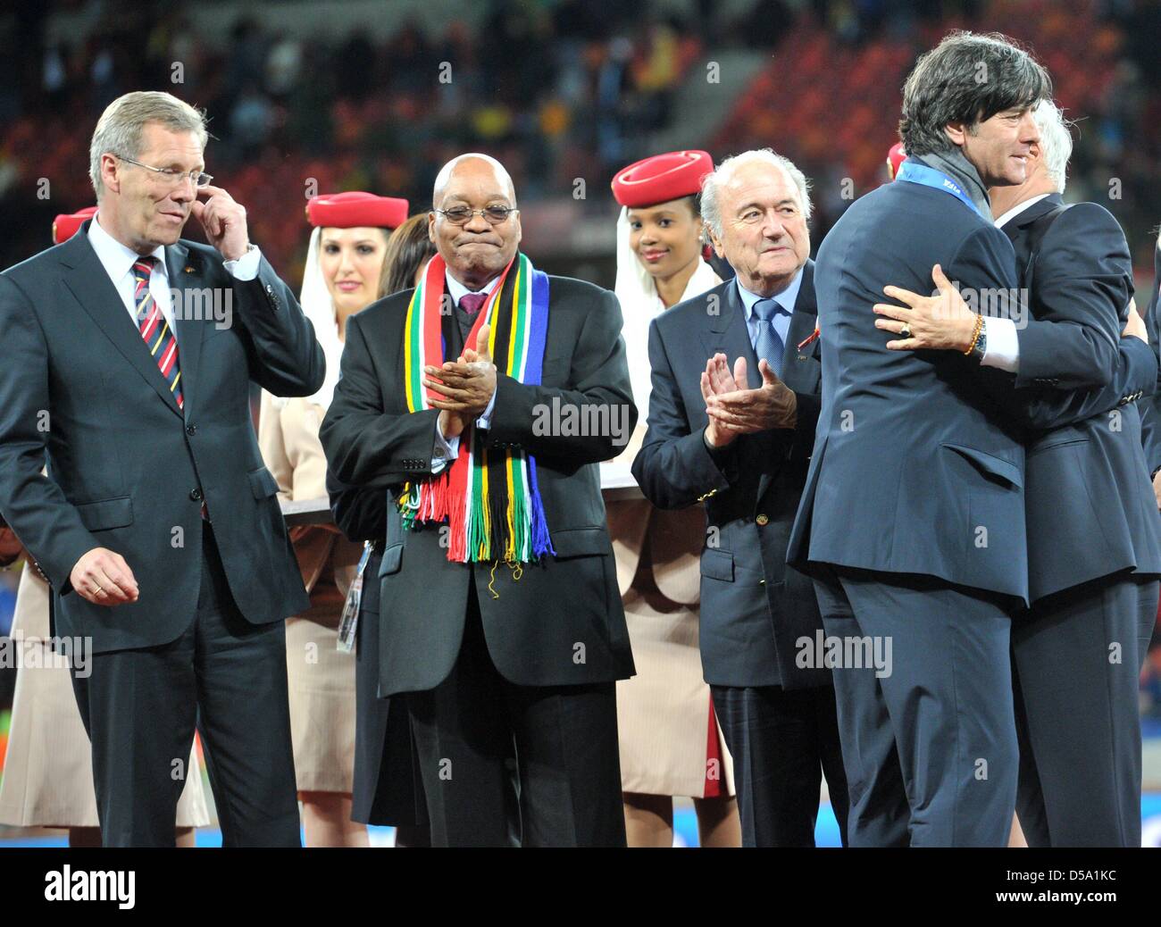 German headcoach Joachim Loew (2-R) receives the bronze medal from Theo ...