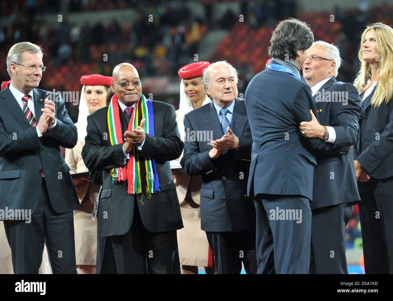 German headcoach Joachim Loew (2-R) receives the bronze medal from Theo ...
