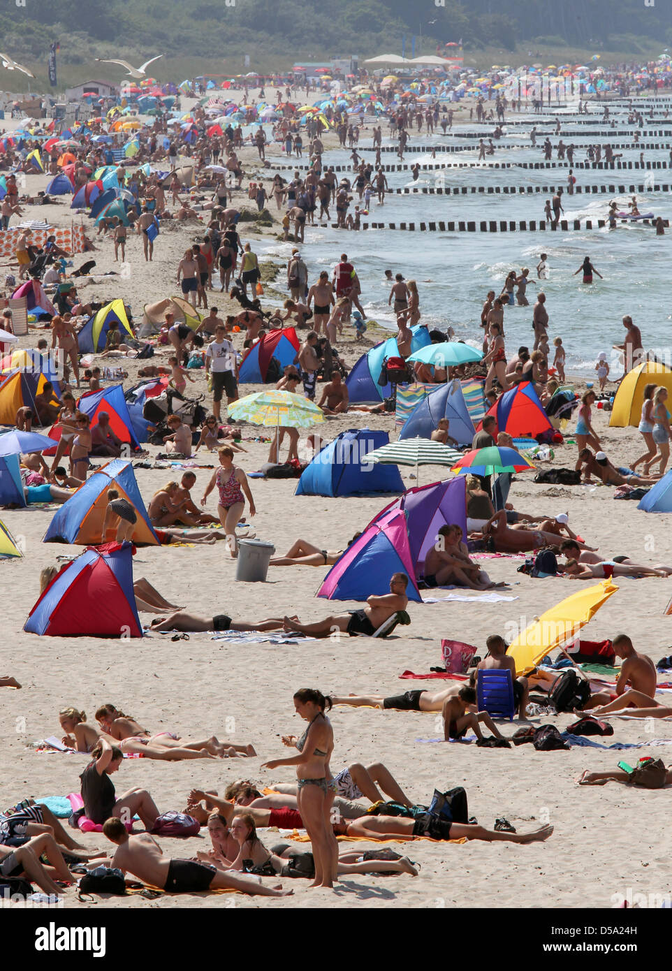 Bathers seek refreshment at midsummer temperatures on the beach in ...