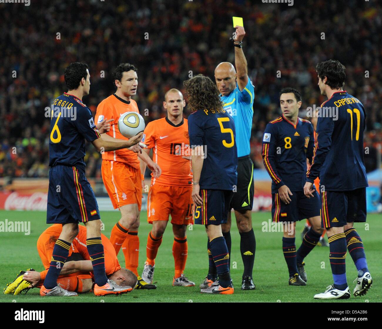 Spain's Carles Puyol (5) is booked with the yellow card by English ...