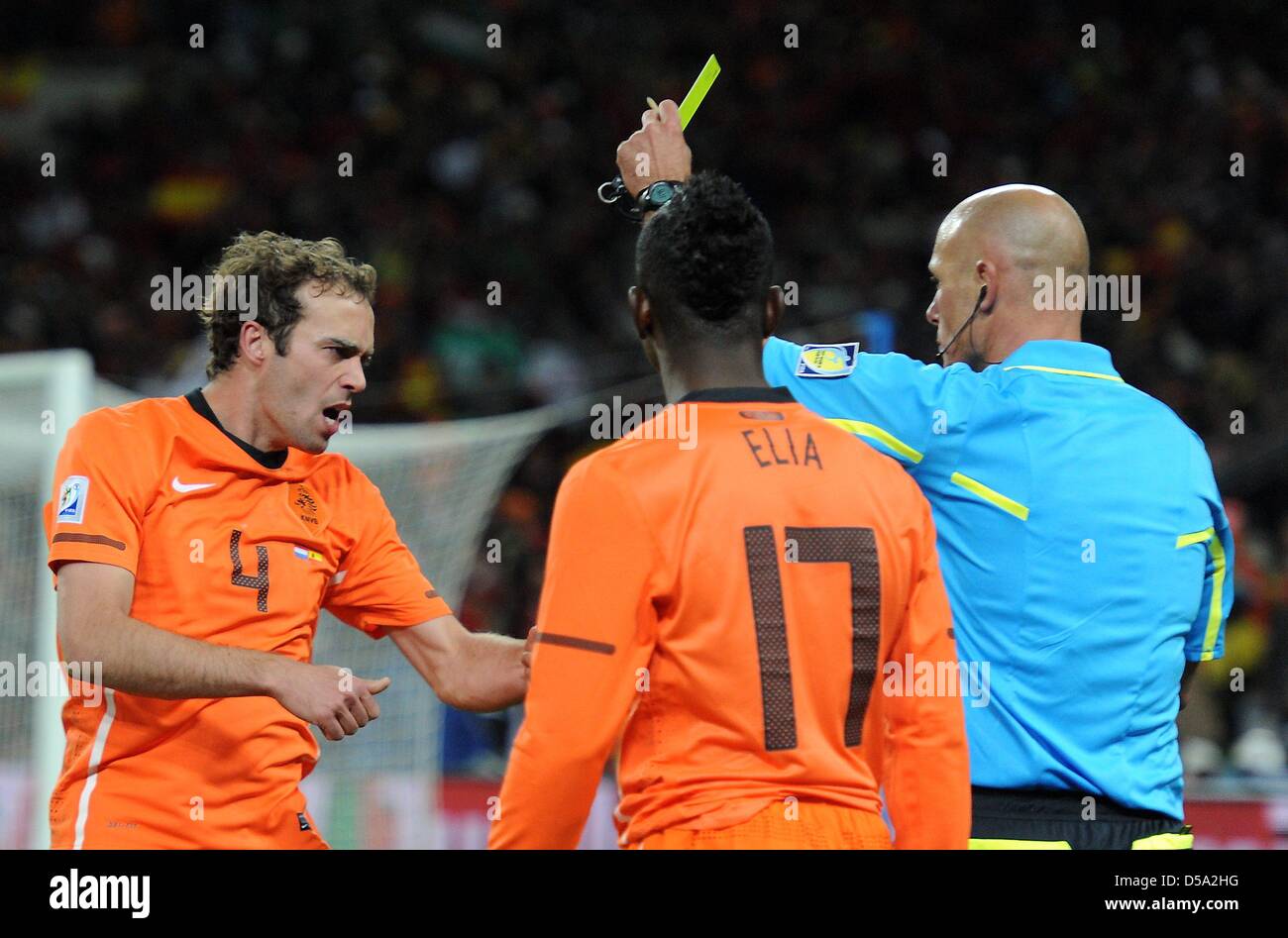 Dutch Joris Mathijsen is booked with the yellow card by English referee ...
