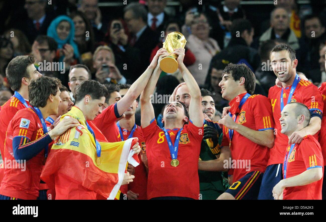Xavi (C) of Spain lifts the trophy after the 2010 FIFA World Cup final ...