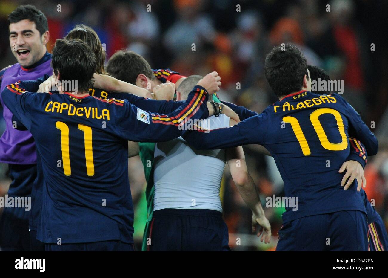 Spain's Andres Iniesta (C) is celebrated by team mates Joan Capdevila ...