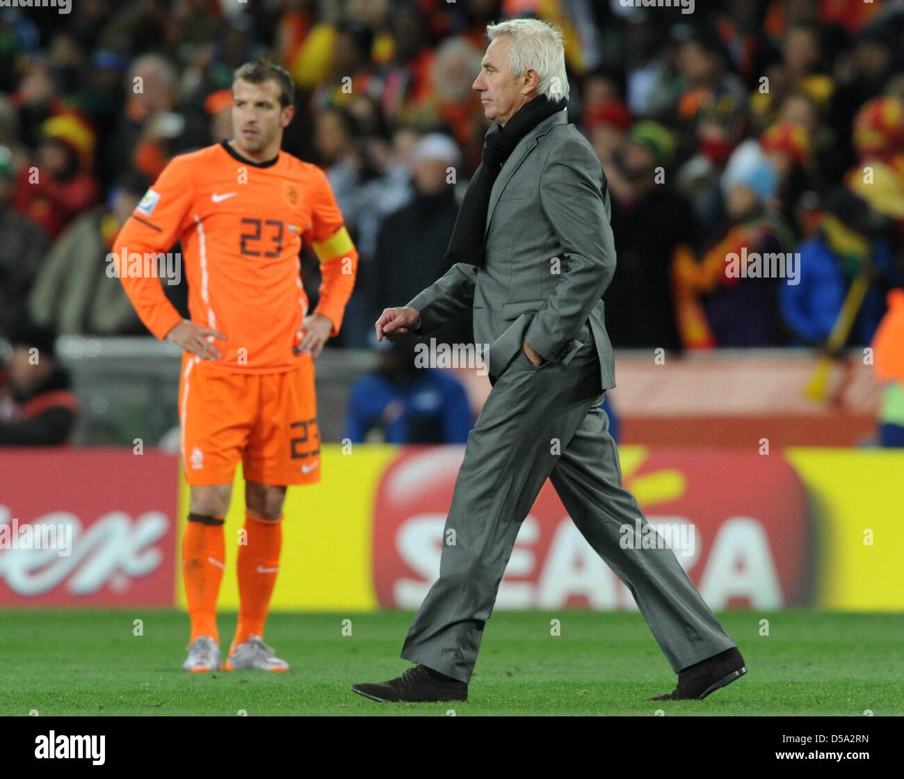 Dutch coach Bert van Marwijk walks over the pitch past player Rafael ...