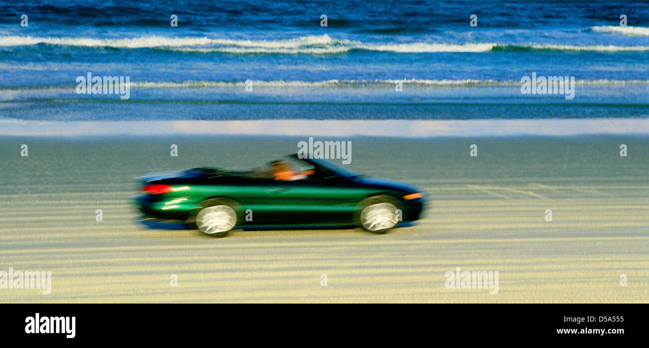 Green convertible car on the beach, moving Stock Photo - Alamy