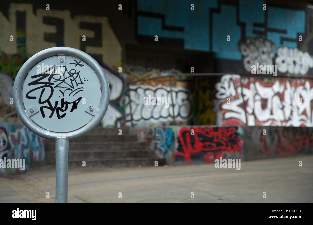 A photograph of some graffiti and a vandalized sign post in Basel ...