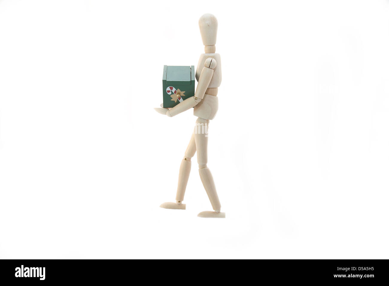 A Wooden Manikin Doll Holding A Green Christmas Box Stock Photo - Alamy