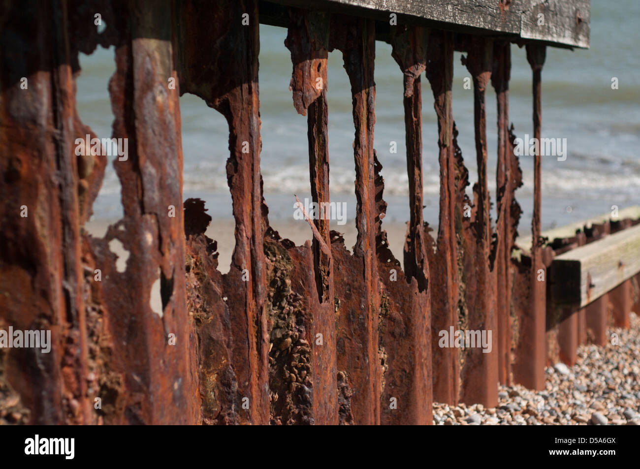 Rust metal groyne on the beach Stock Photo - Alamy