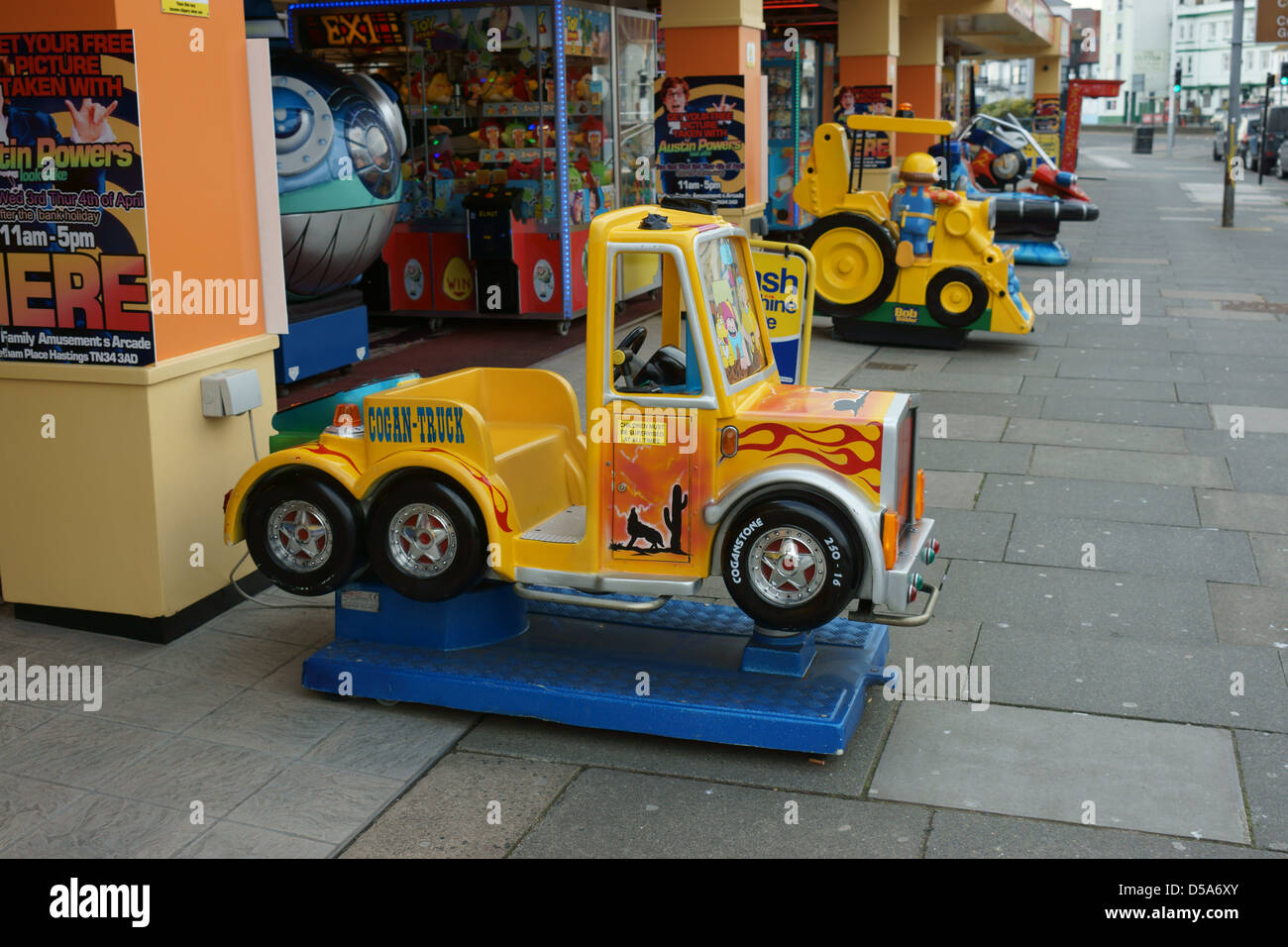 Hastings amusement arcade rides pavement sidewalk Stock Photo - Alamy