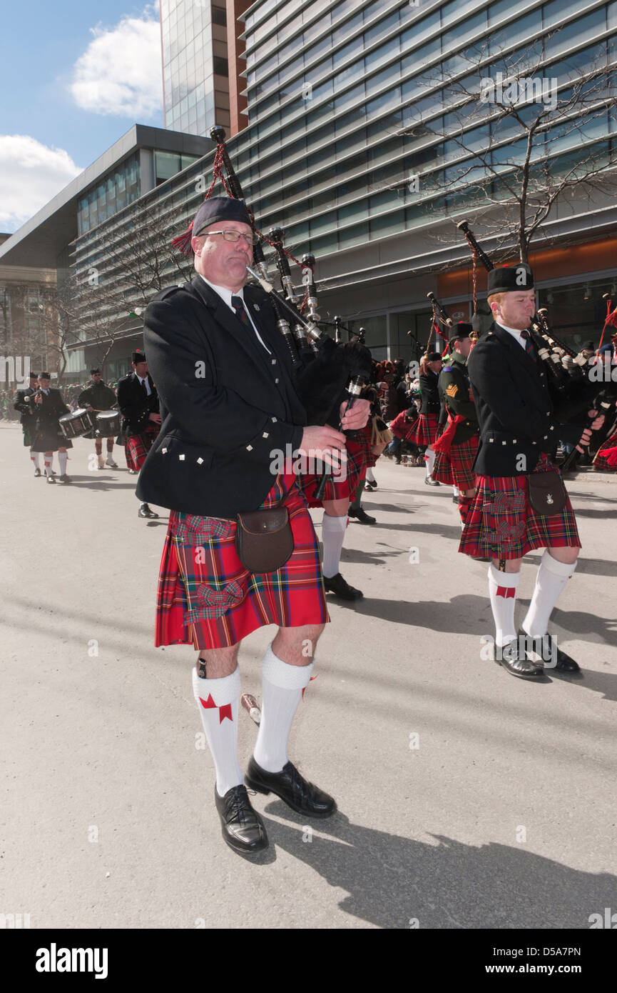 Traditional pipe band marching on Ste Catherine street in Montreal ...