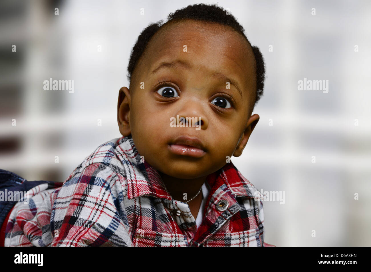 Portrait of a boy who is inside his home Stock Photo - Alamy
