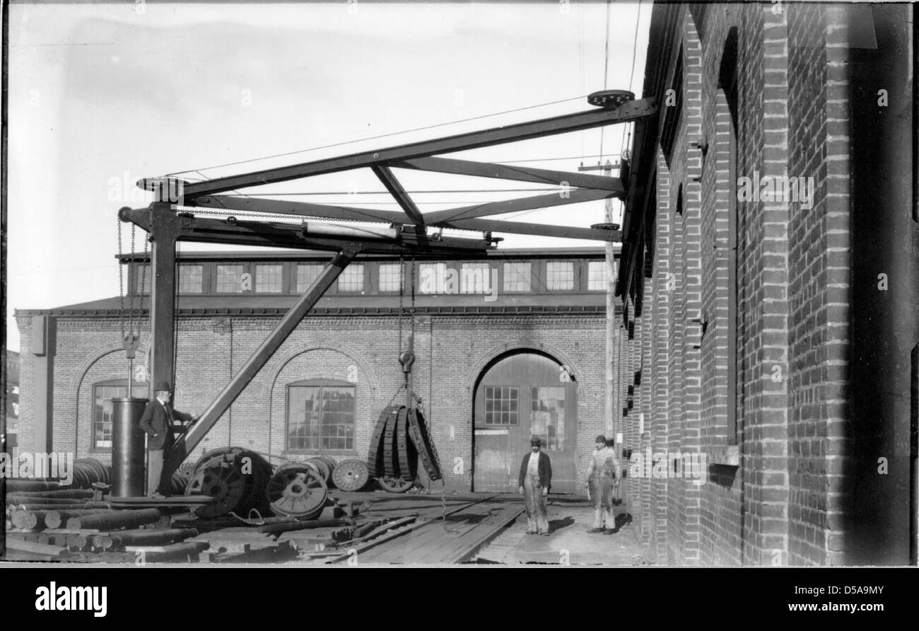 The image captures two workers at a railroad shop, showcasing the ...
