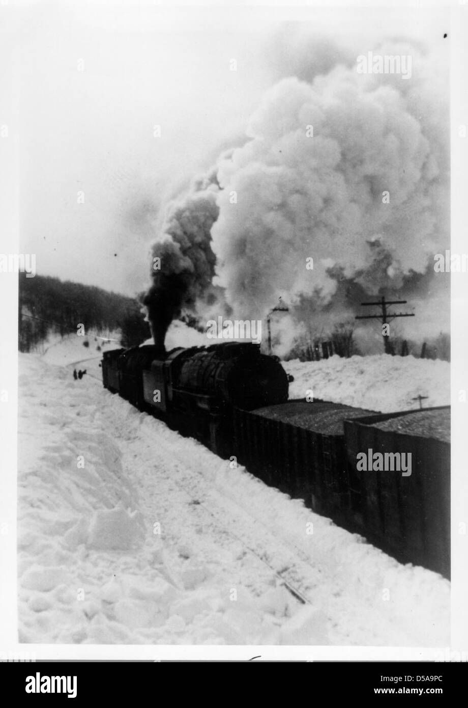 A dramatic photograph depicting a train wreck involving two locomotives ...