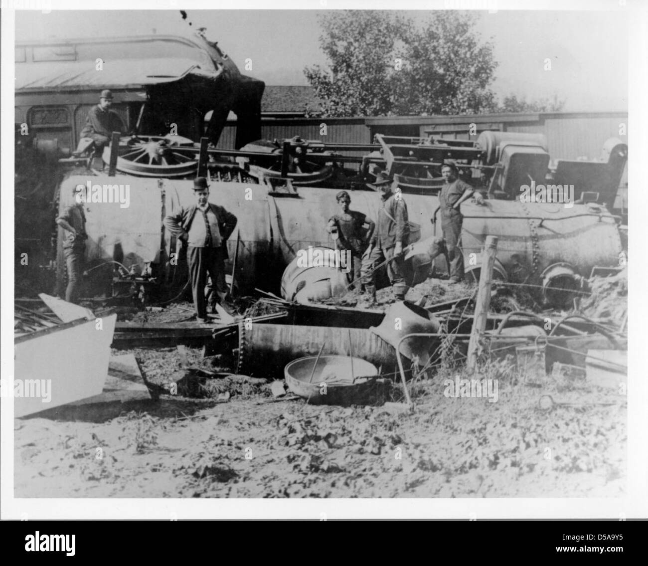 This photograph depicts the aftermath of a train wreck involving the ...
