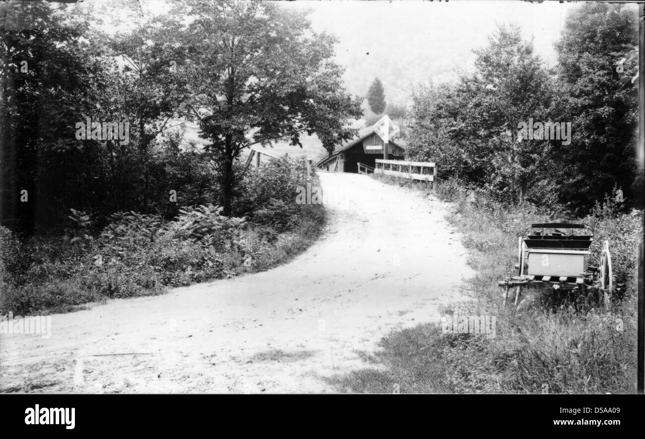 This photograph features a rural country road intersecting with a ...