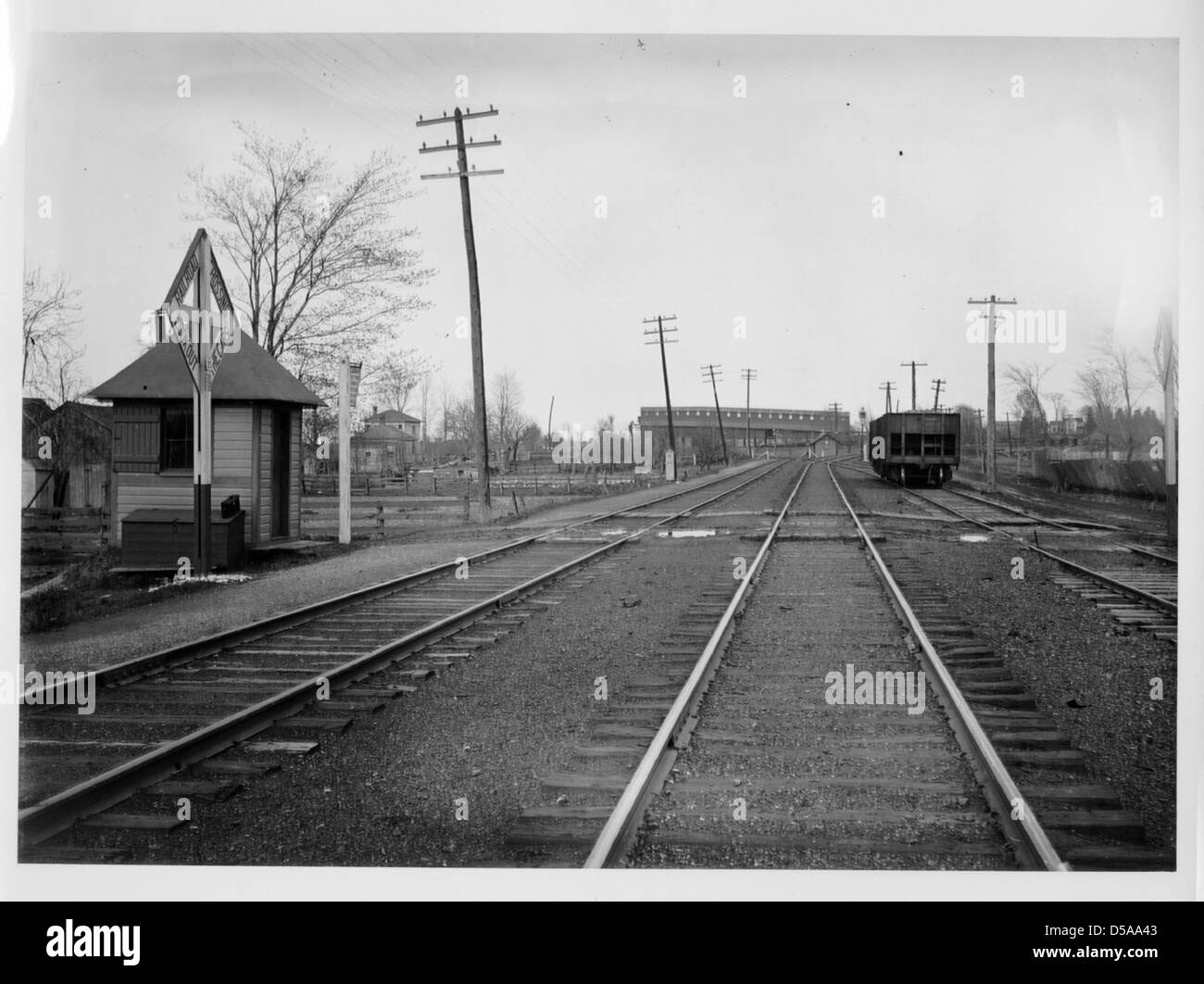 This photograph shows a watchman's shed located alongside two railway ...