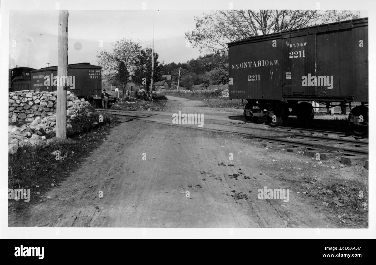 A historical image of railroad freight cars crossing tracks, likely ...