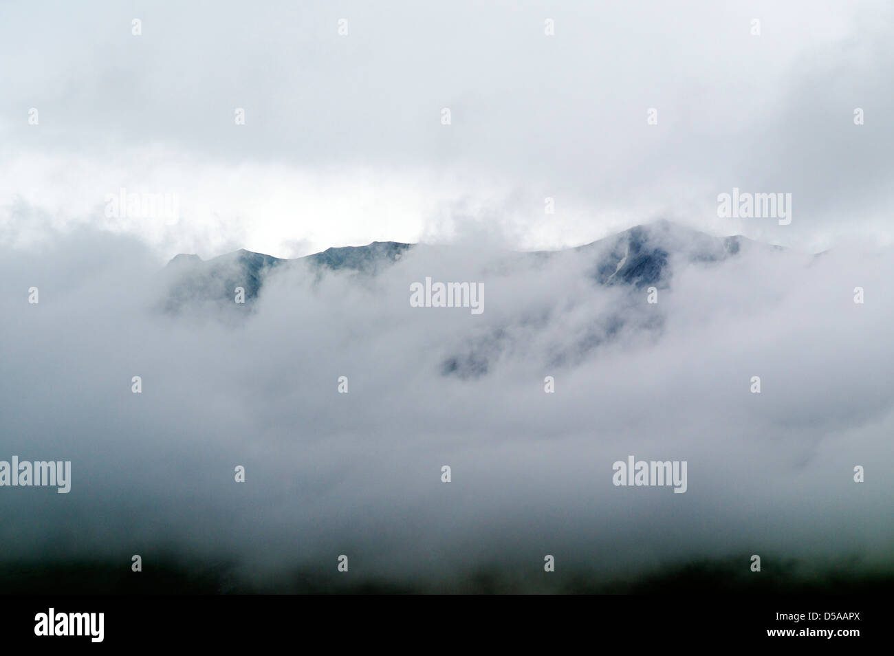 Low clouds, mist and fog partially obscure the Alaska Range, Denali ...