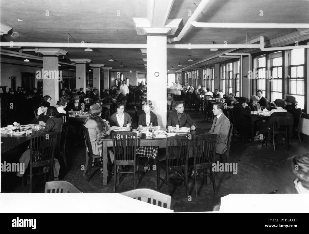 A photograph from around 1915-1920 showing diners in a home economics ...