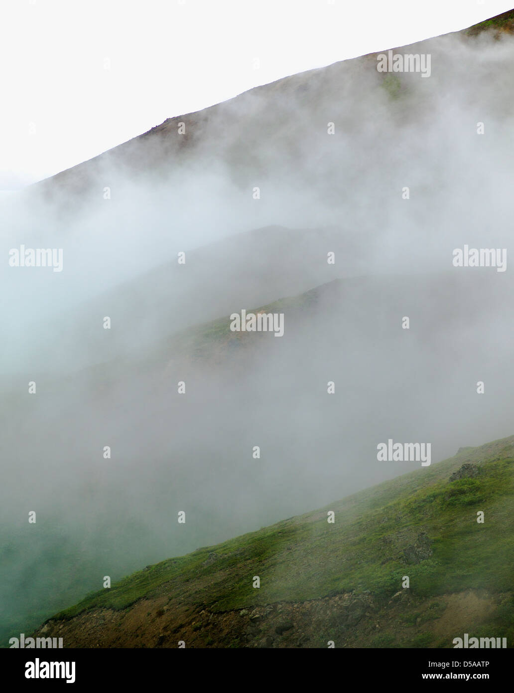 Low clouds, mist and fog partially obscure the Alaska Range, Denali ...
