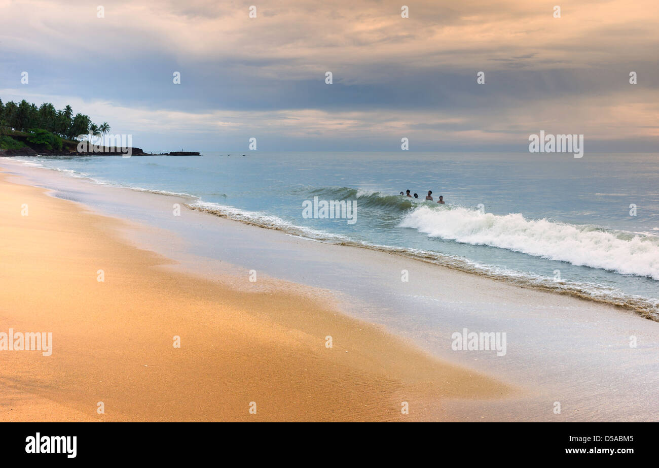 Swimmers enjoy the warm waters of the Arabian Sea off a deserted ...