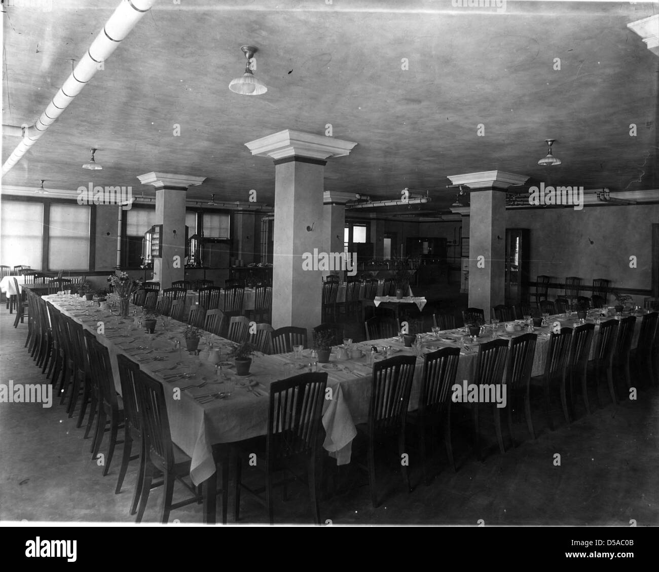 A photograph showing the dining room of a Home Economics cafeteria set ...