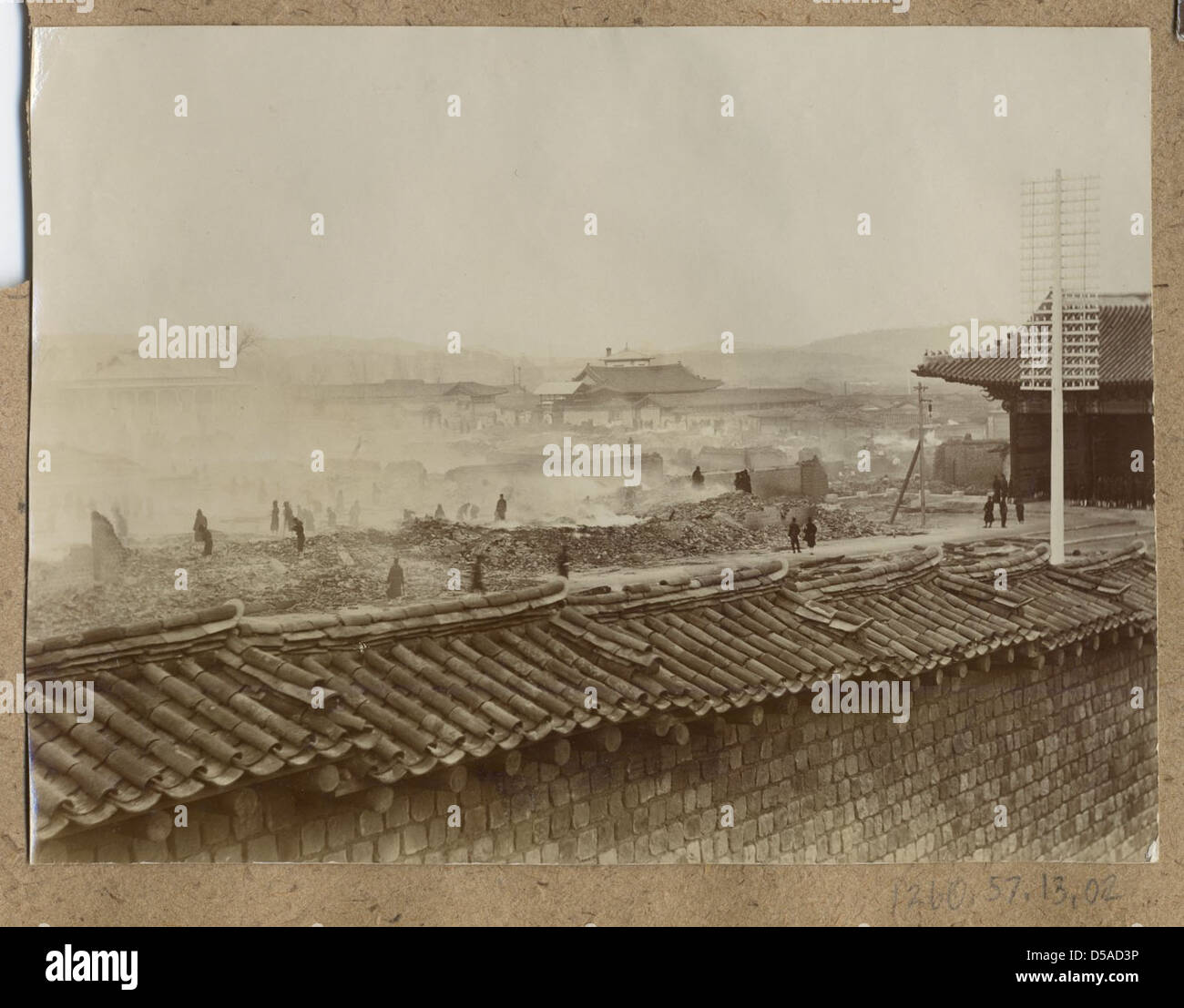 [View over wall onto smoldering ruins] Stock Photo - Alamy