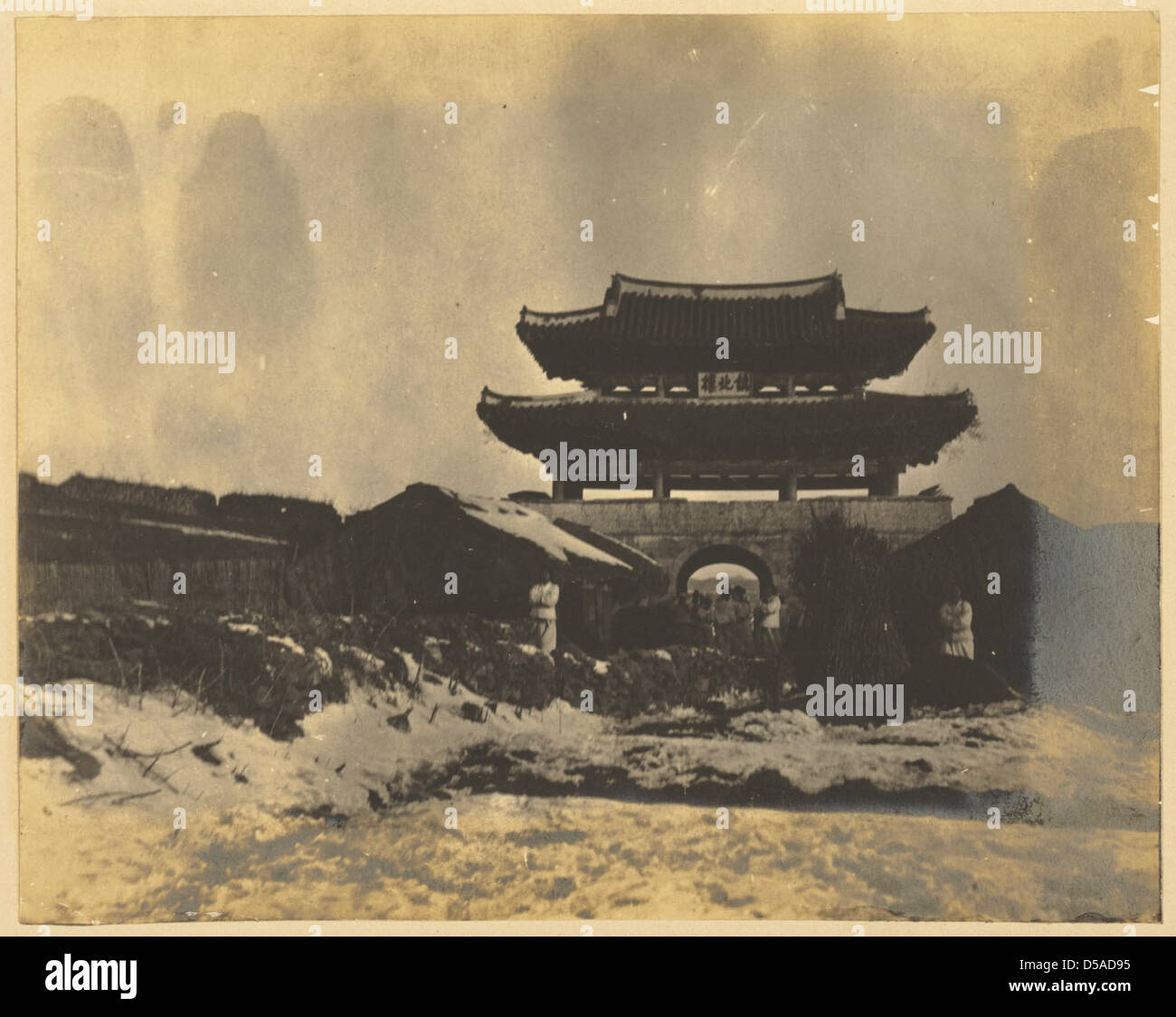 A photograph showing a procession emerging from a gate, likely a ...