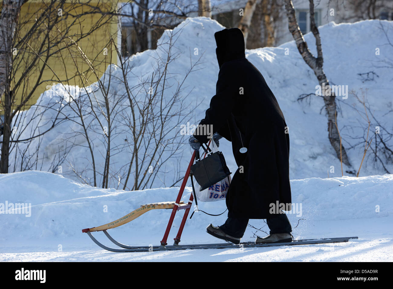 old woman carrying shopping home using a kicksled spark kirkenes ...