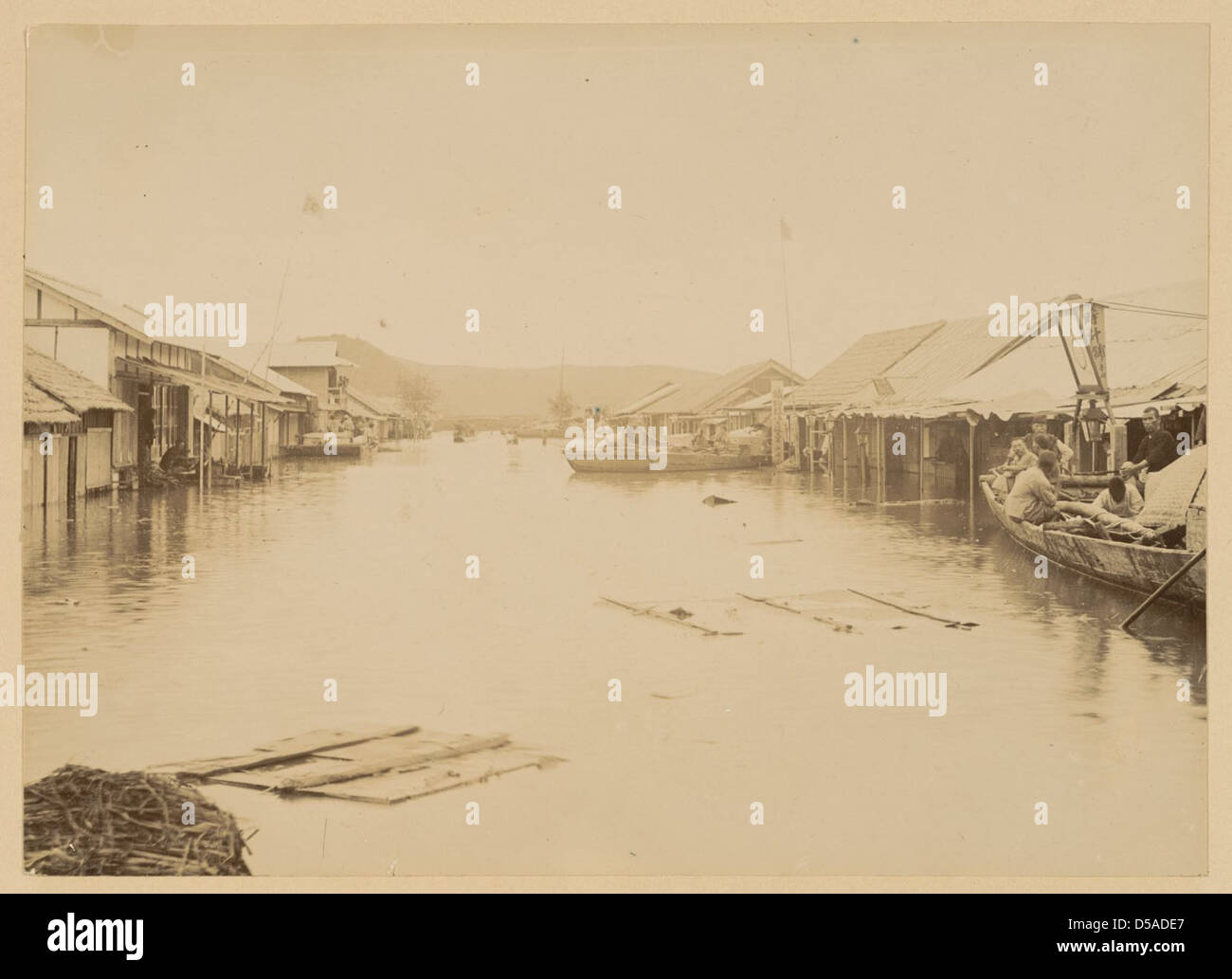 This photograph shows a flood scene, capturing the aftermath of heavy ...