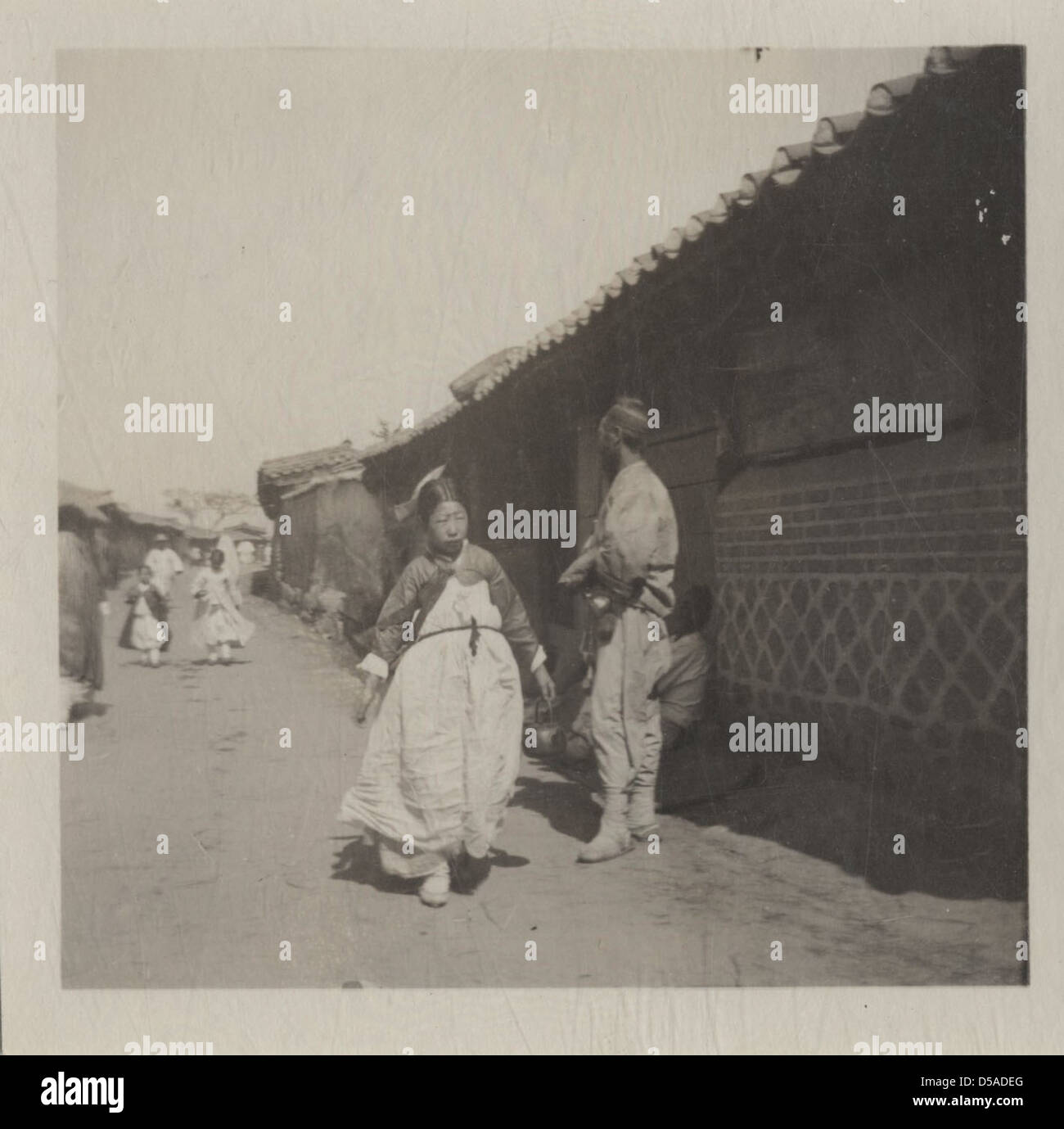 A man wearing a traditional topknot hairstyle is captured in this ...