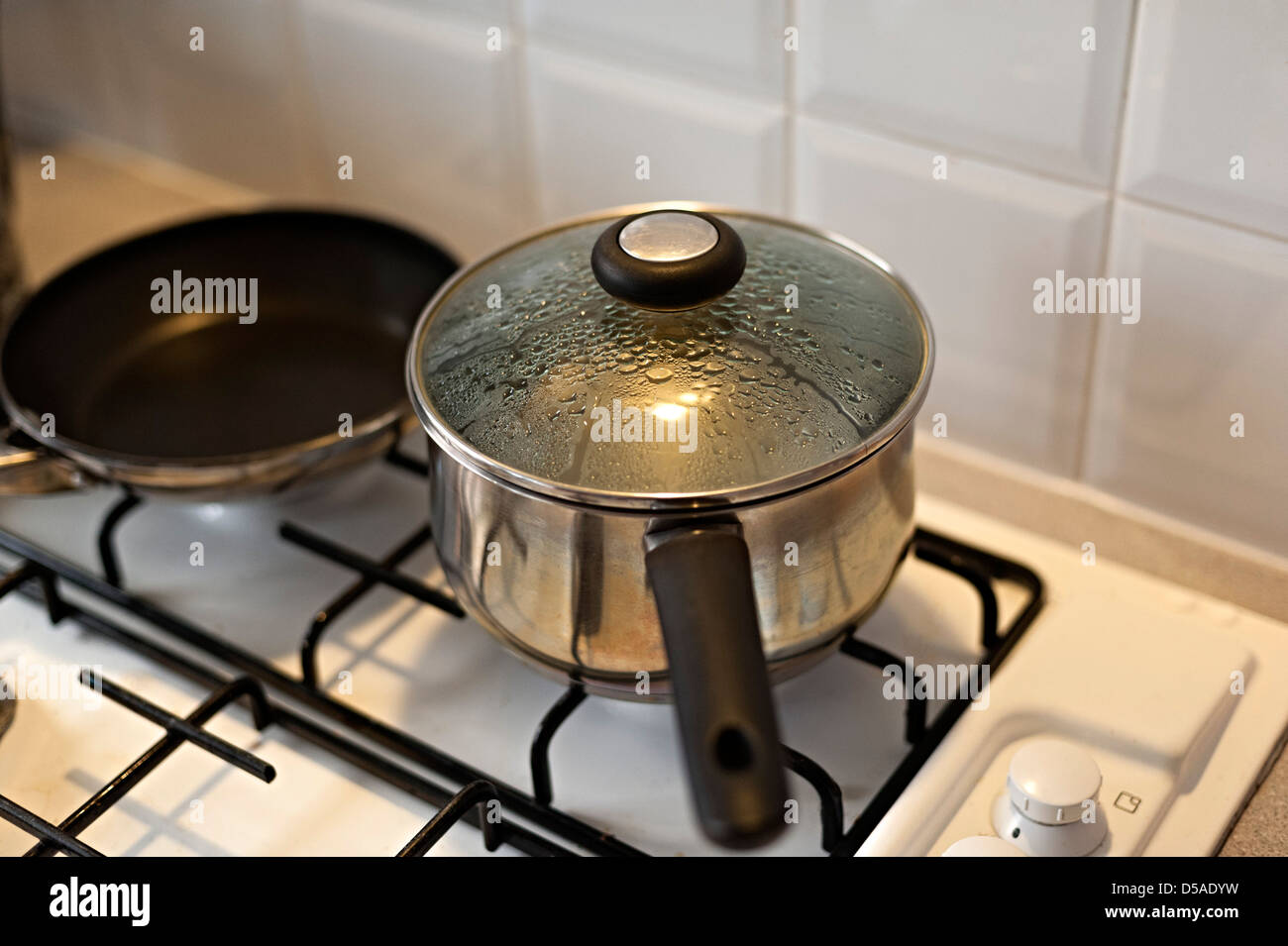 a bolling pan on a stove with the lid on Stock Photo - Alamy