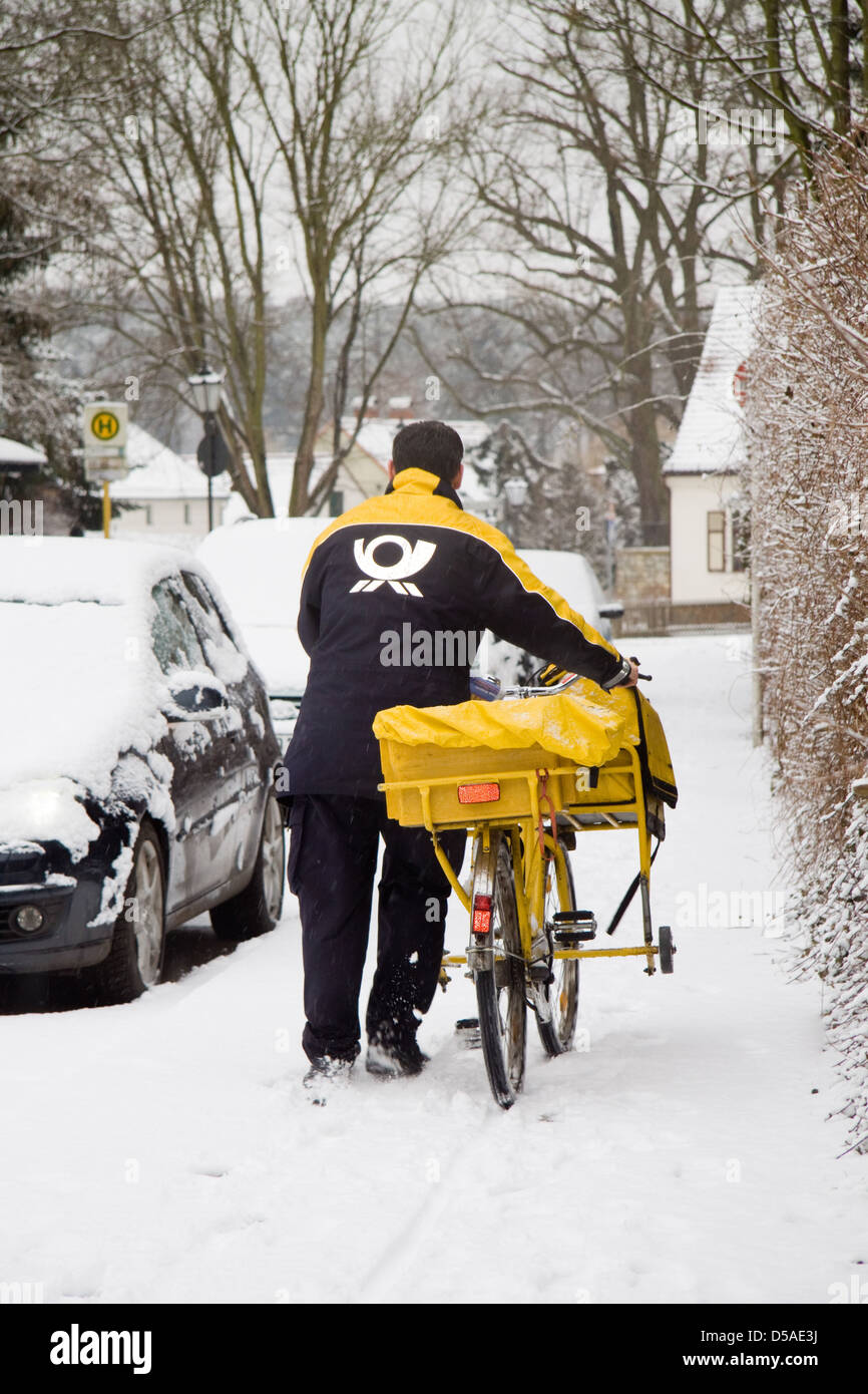 Berlin, Germany, a postman in the snow on the way Stock Photo - Alamy