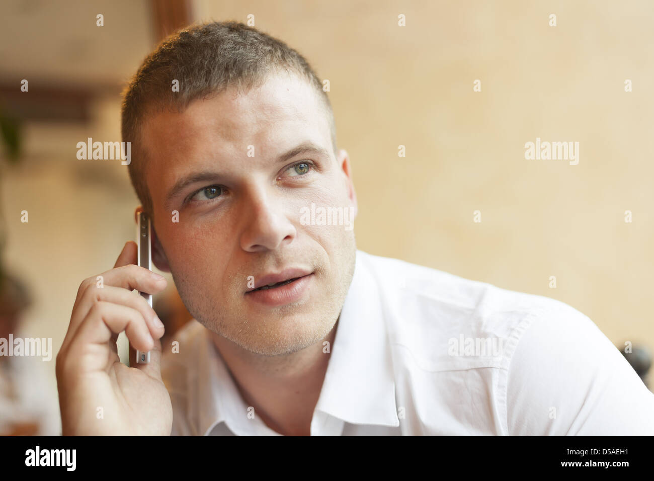 Men with smart phone speaking, blurred background, business building ...