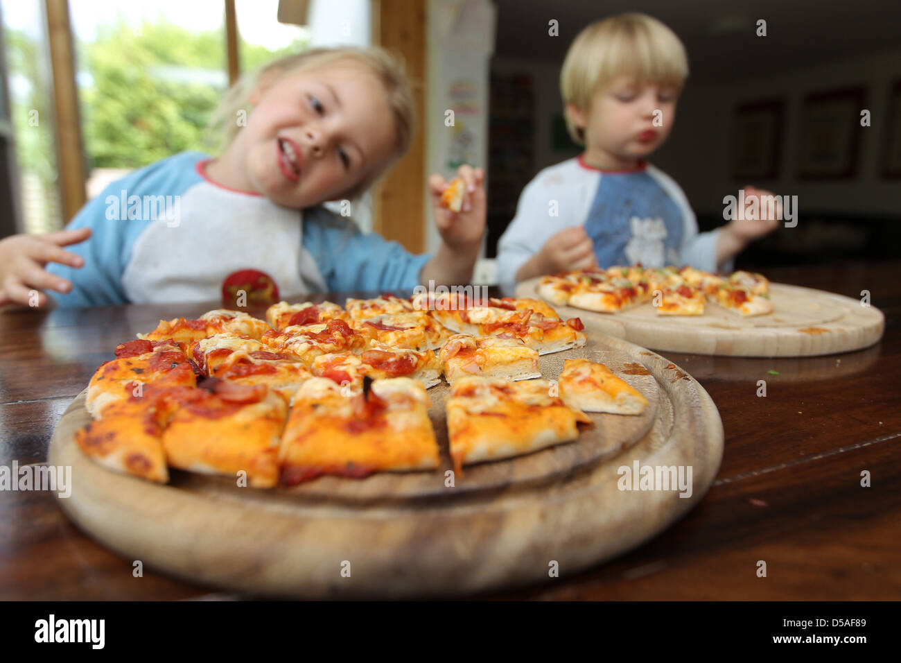 Handewitt, Germany, children eat a minced homemade pizza Stock Photo ...