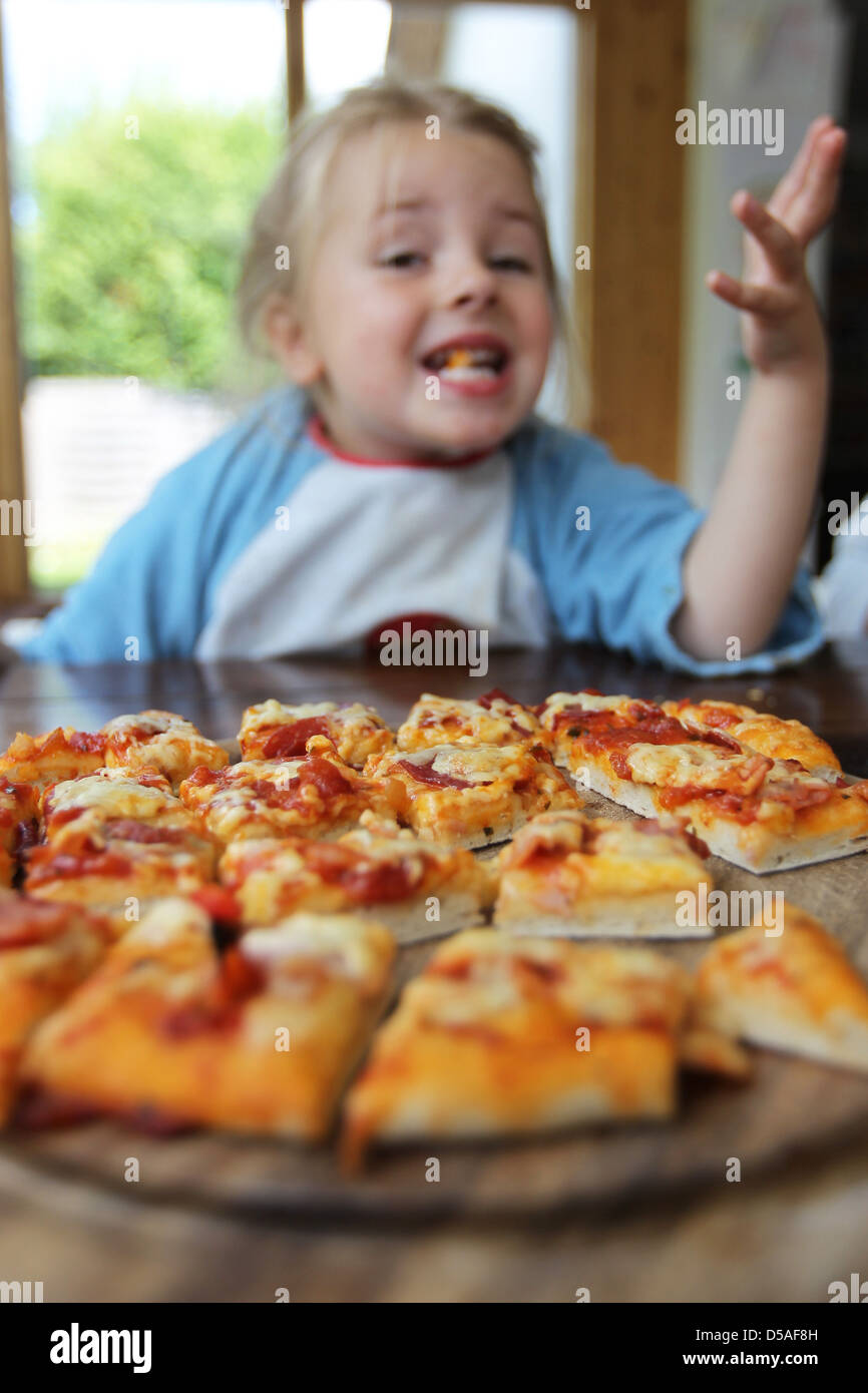 Handewitt, Germany, a girl eats a minced homemade pizza Stock Photo - Alamy