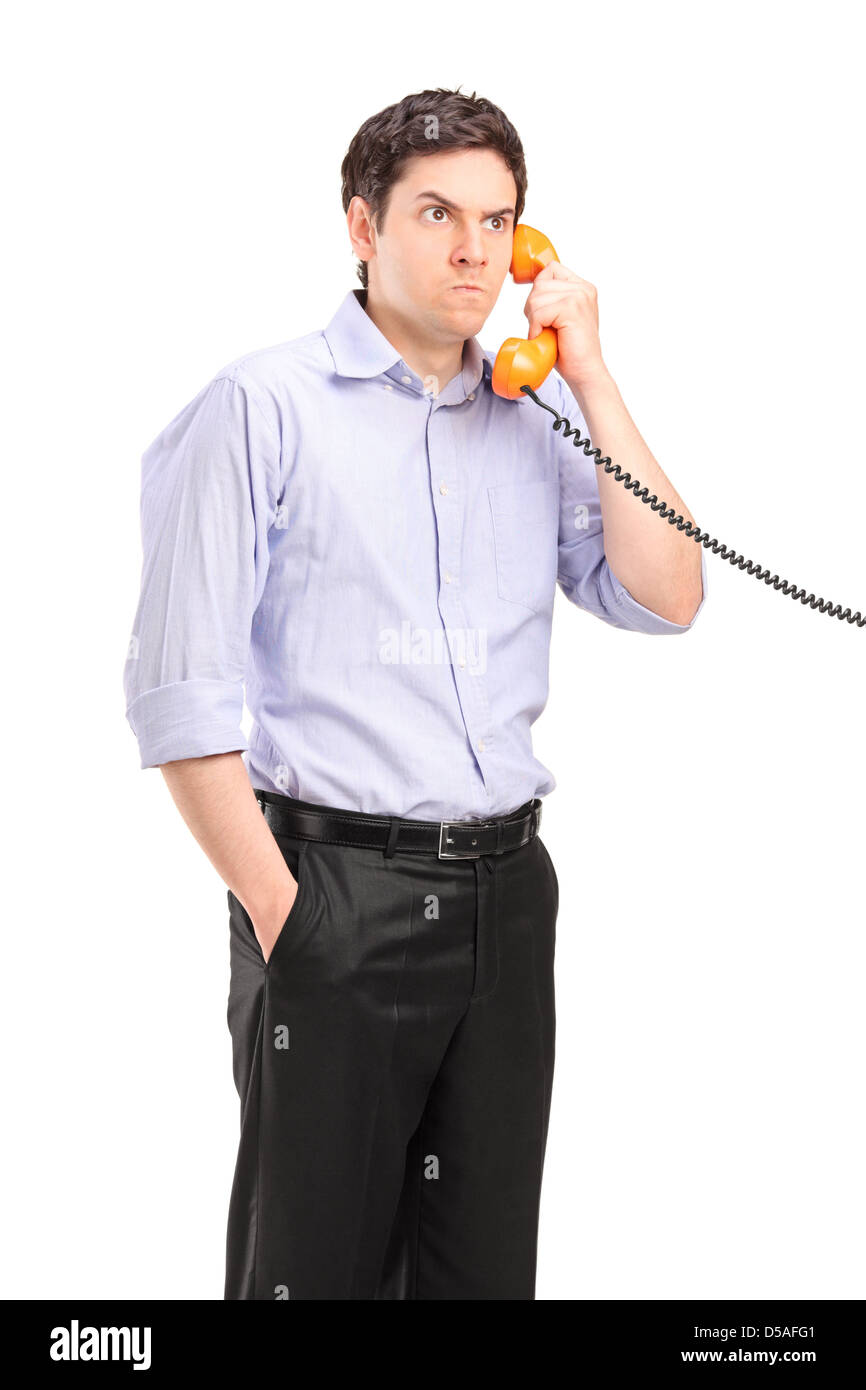 Angry man having a telephone conversation, isolated on white background ...