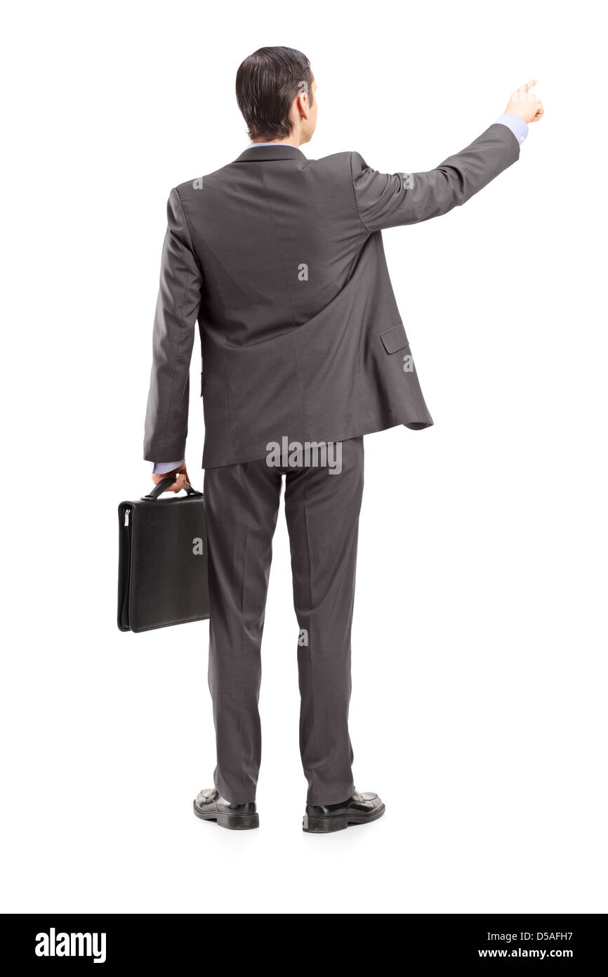 Full length portrait of a businessman pointing in a direction, shot ...