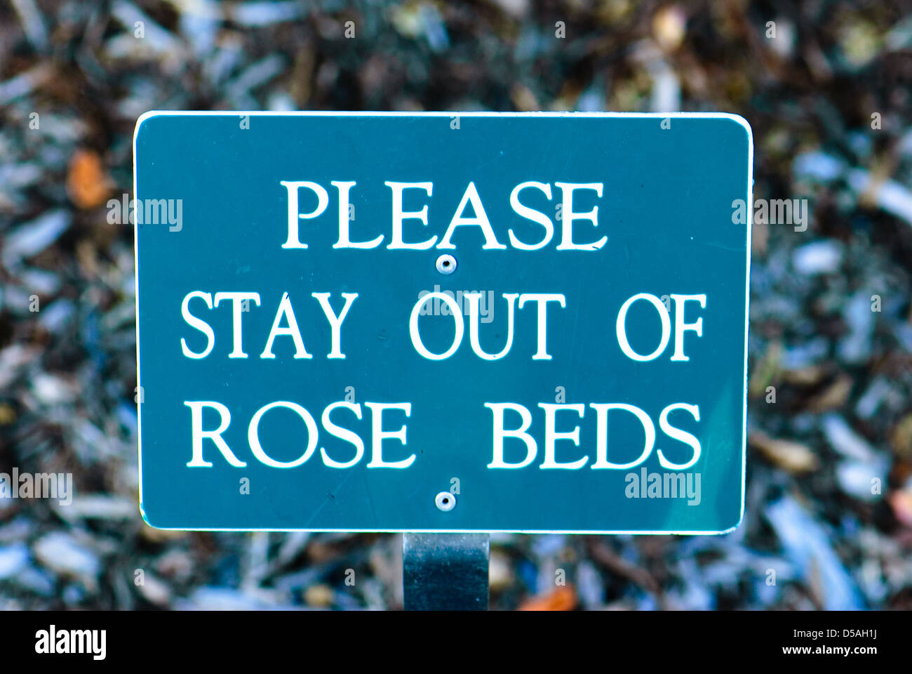 Sign that says Please stay out of rose beds Stock Photo - Alamy