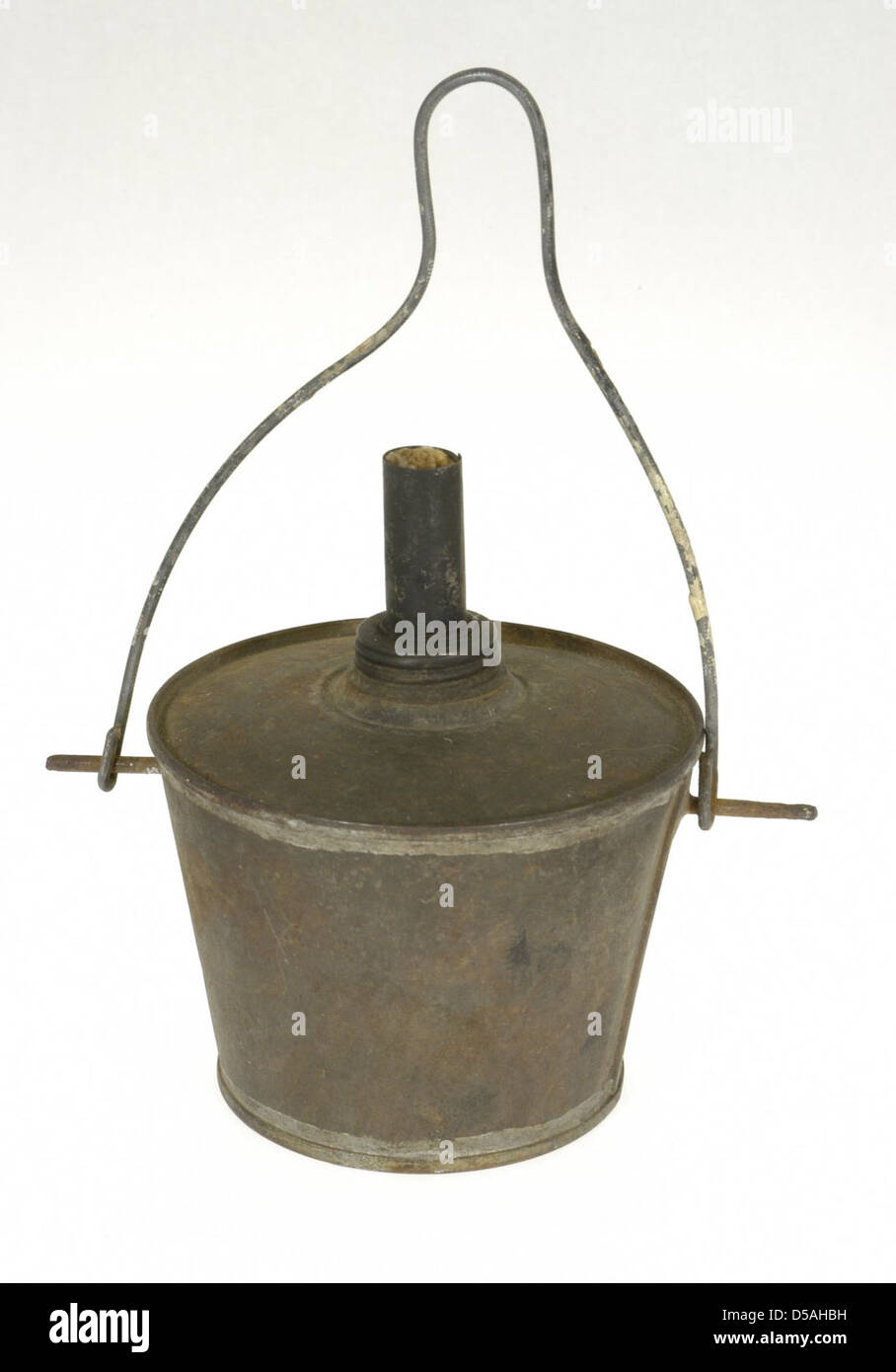 A photograph of a bucket-shaped tin torch light, used for lighting ...