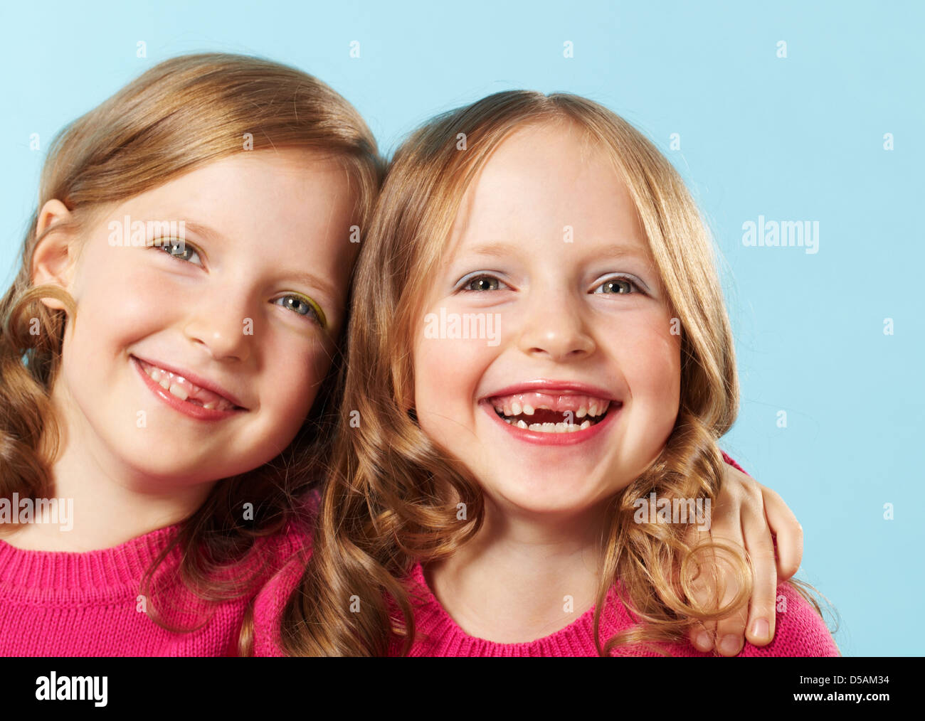 Close-up image of cheerful twins wearing make-up Stock Photo - Alamy