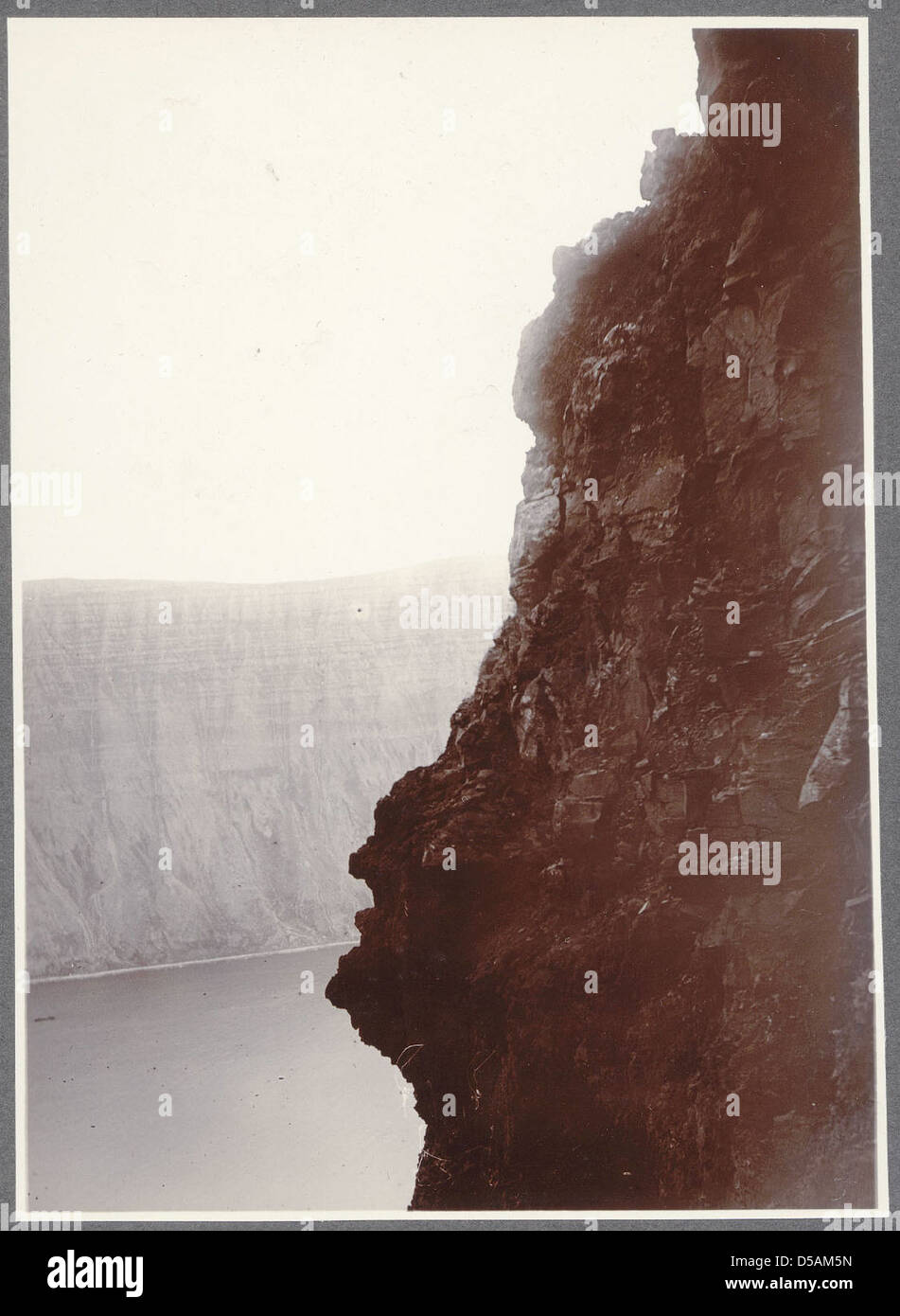 This photograph captures the dramatic cliff edge above the town of Safj ...