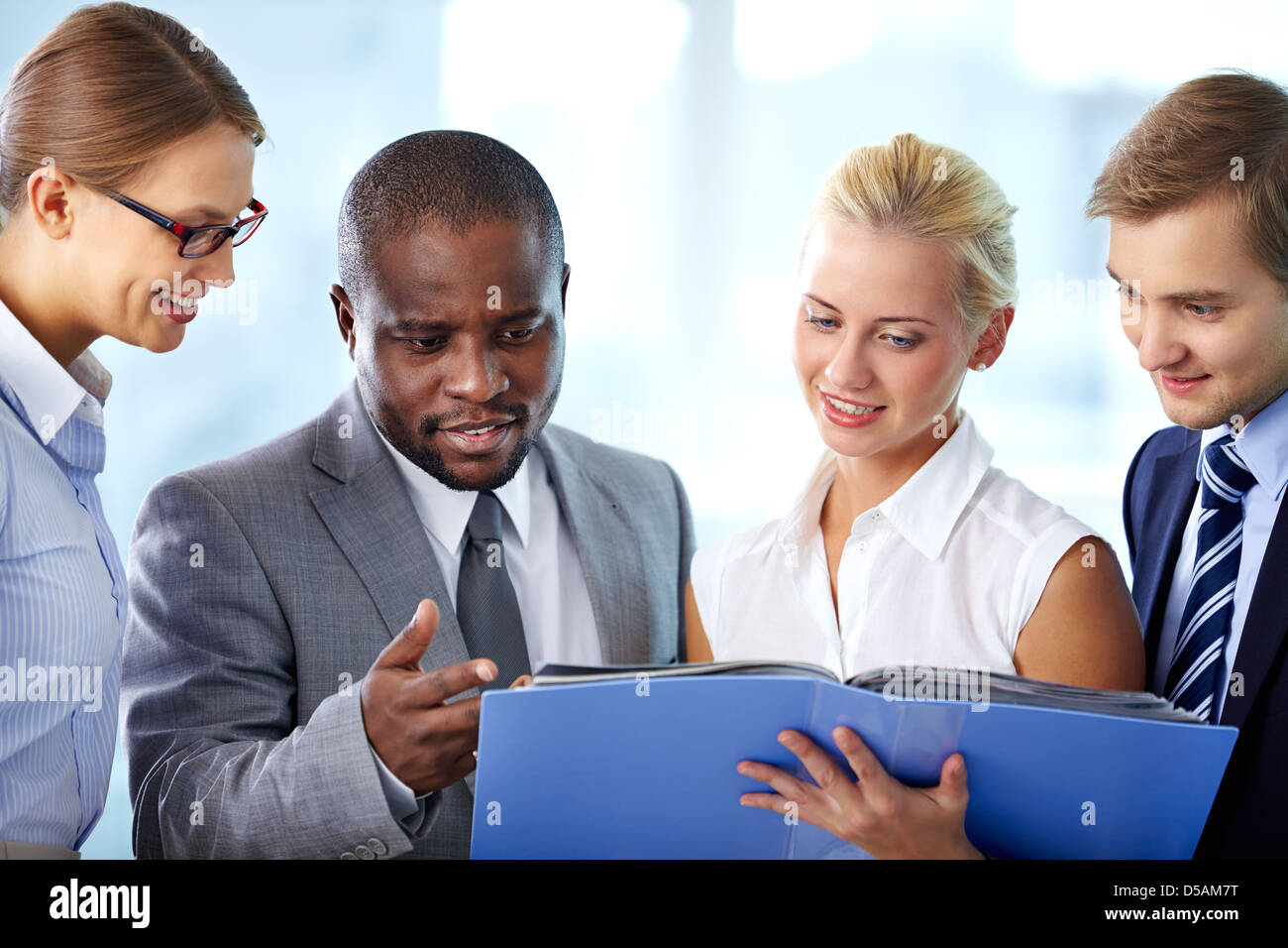 Gathered team of four making an important choice Stock Photo - Alamy