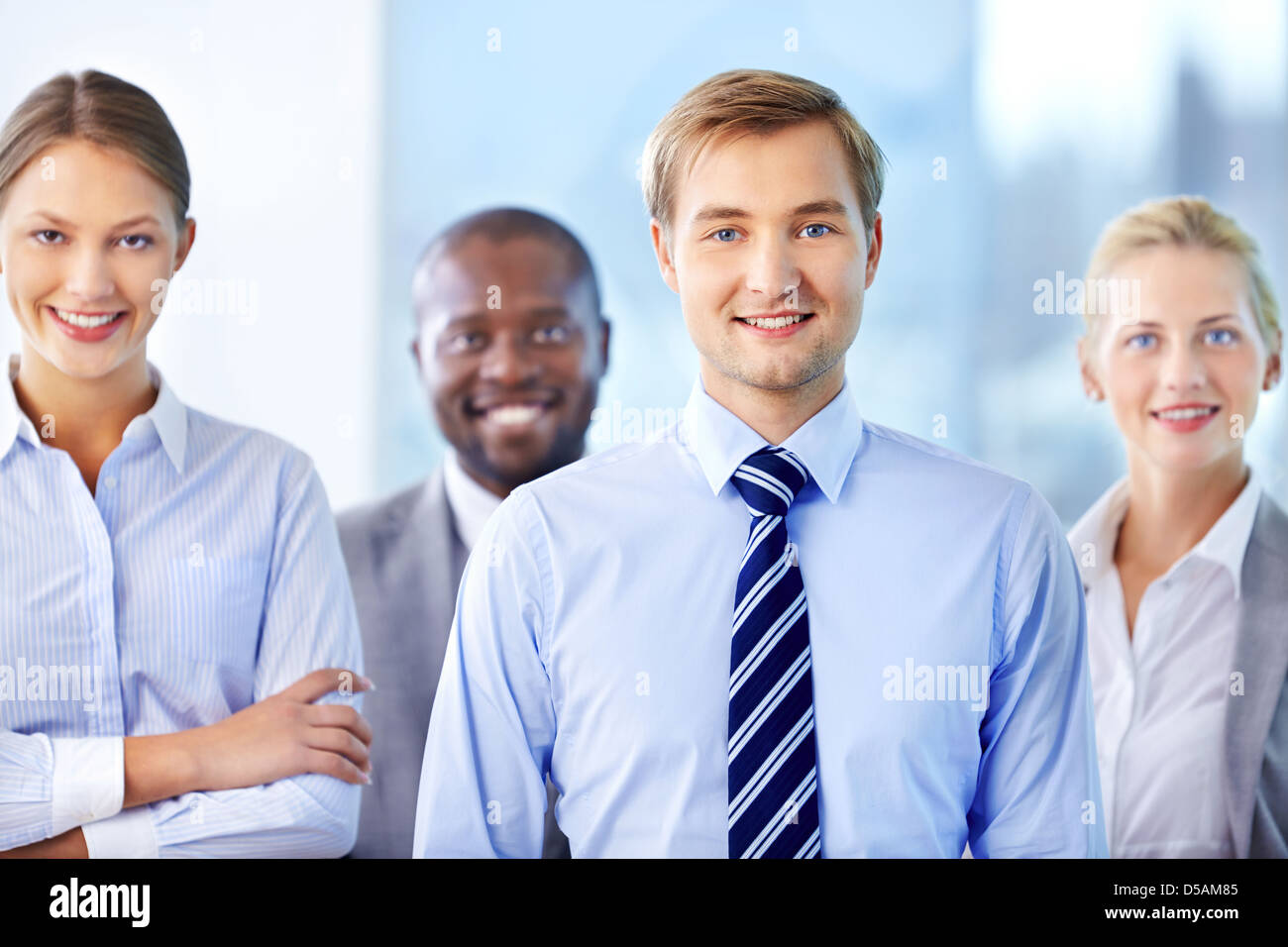 Portrait of a confident team with a handsome leader Stock Photo - Alamy