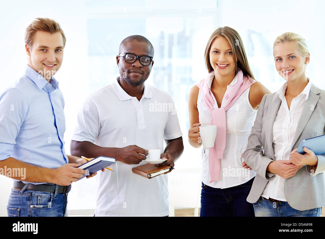 Multi-racial team of four being ready to collaborate Stock Photo - Alamy