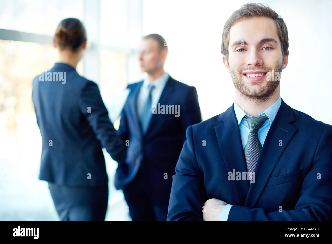 Portrait of a handsome business leader smiling confidently at the ...